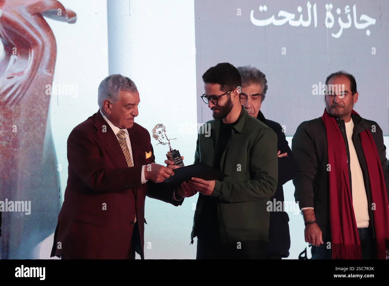 Archaeologist Zahi Hawass presents one of the winners with the award at ...