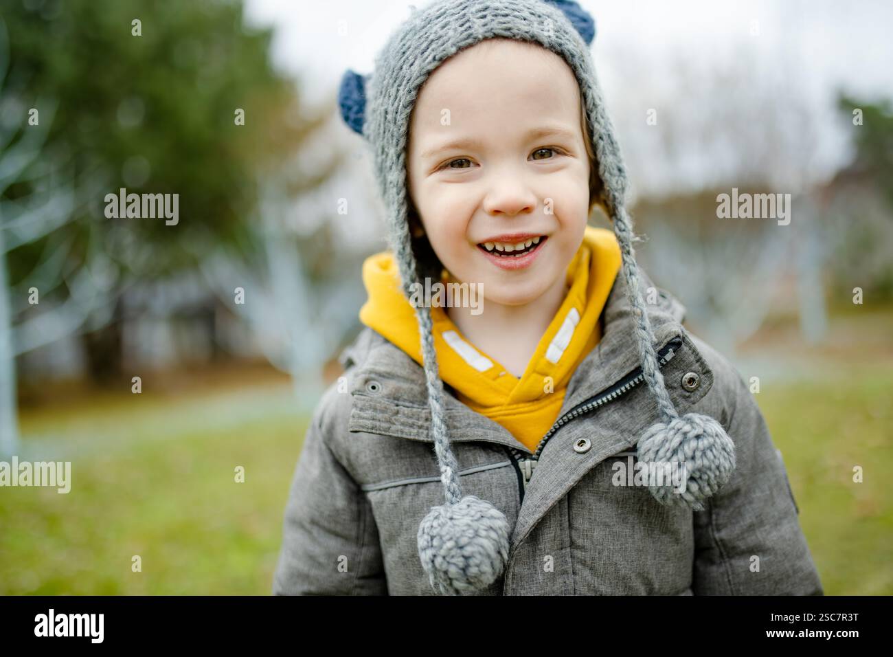 Funny little boy having fun outdoors on early spring day. Child ...