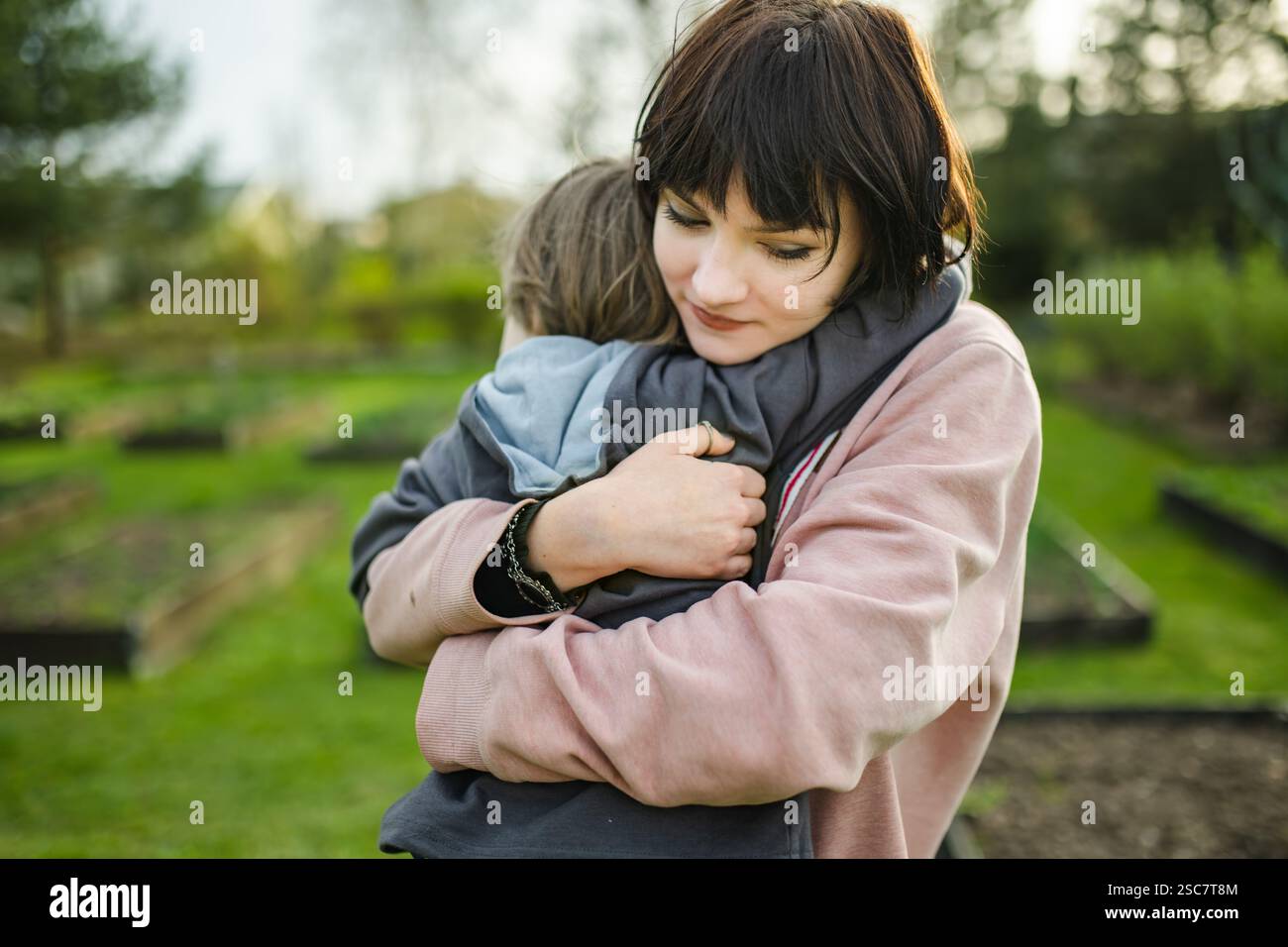 Cute big sister cuddling with her toddler brother. Adorable teenager ...