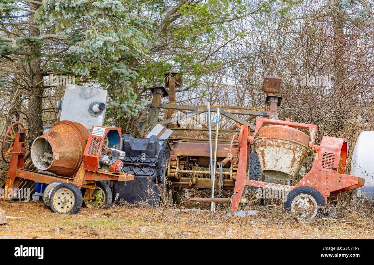 several old used concrete mixers sitting in a winter landscape Stock ...
