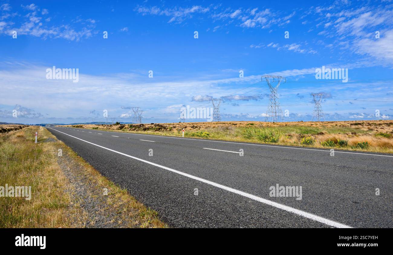 Desert Road in summer. Power pylons and power lines along the highway ...