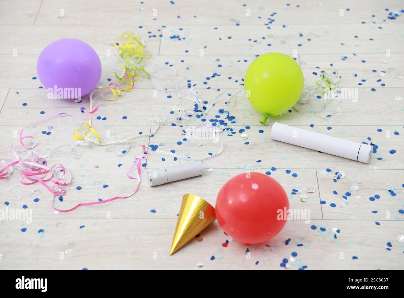Confetti poppers, serpentine streamers and other party decor on floor ...