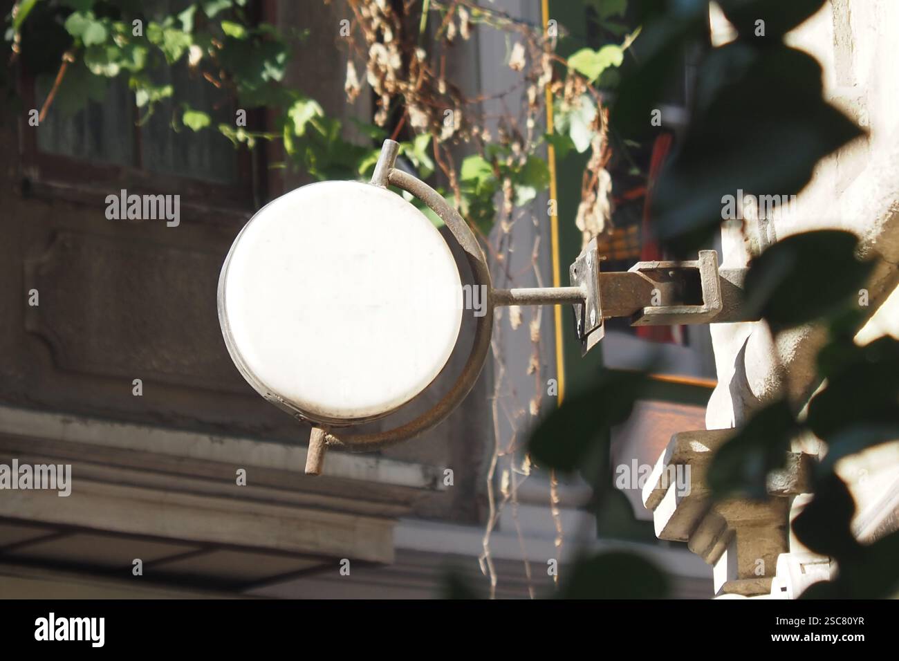 Vintage circular sign mounted on a city building during daytime Stock ...