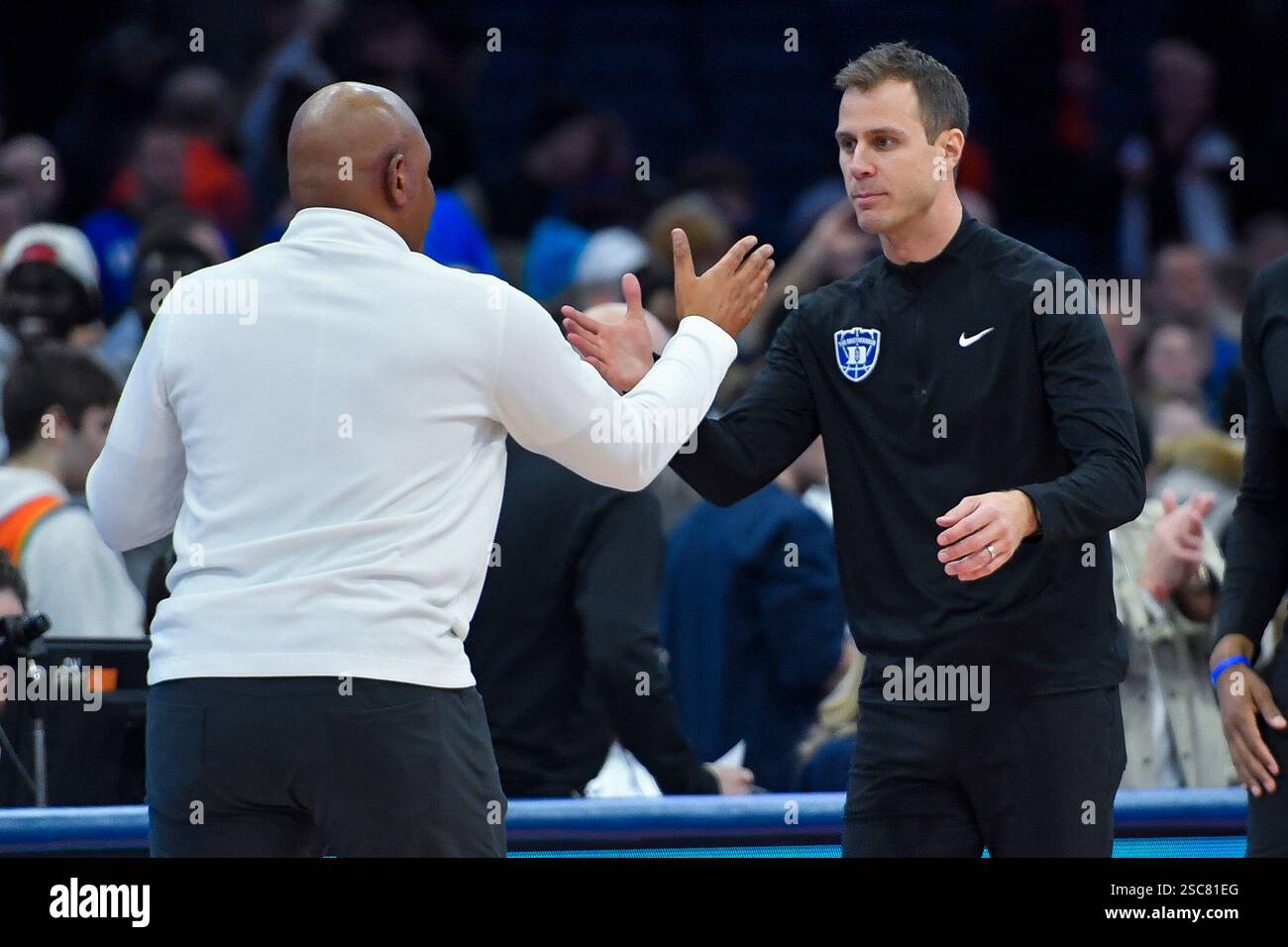 Duke head coach Jon Scheyer, right, shakes hands with Syracuse head ...