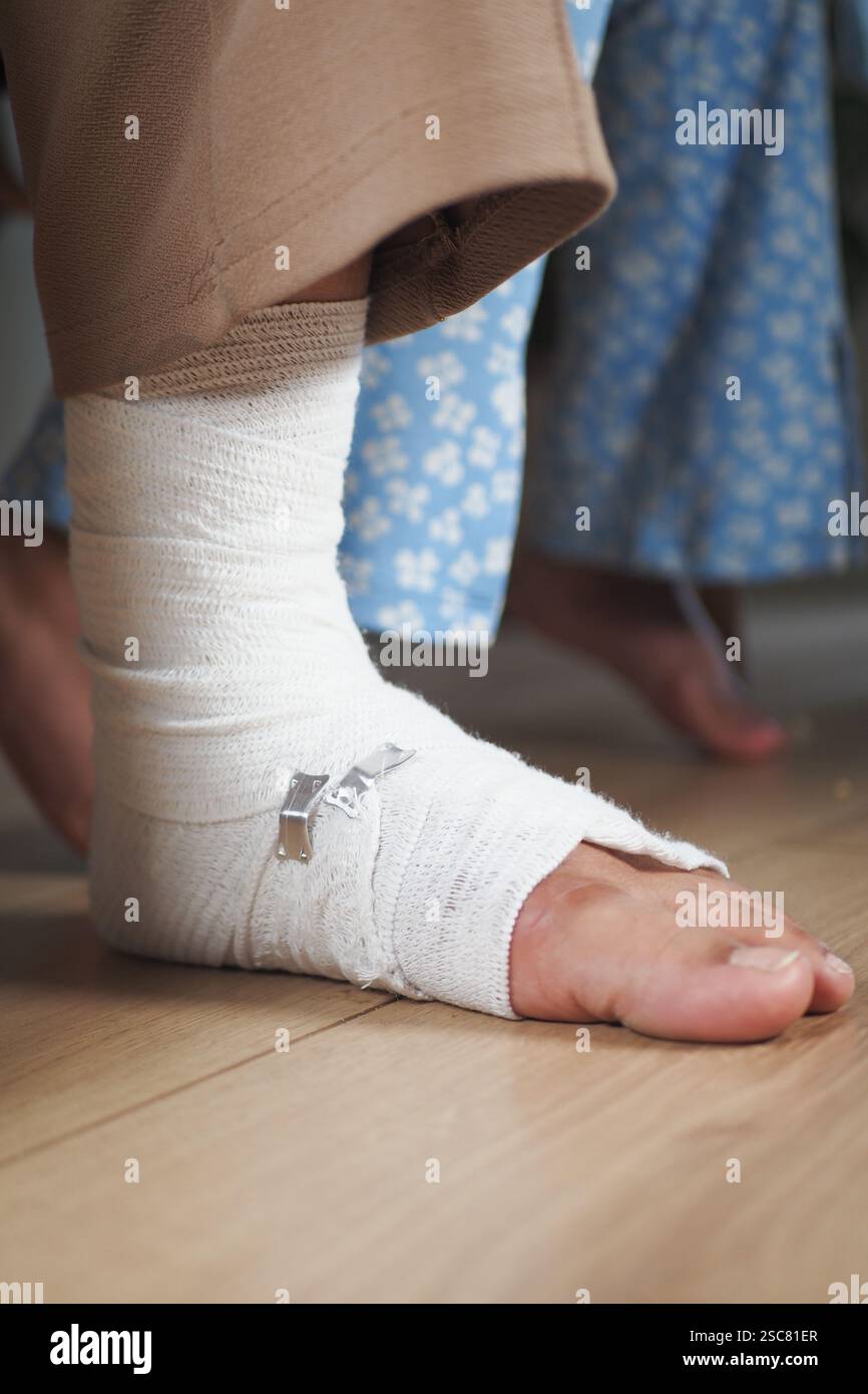 Injury recovery with a bandaged foot at home Stock Photo - Alamy