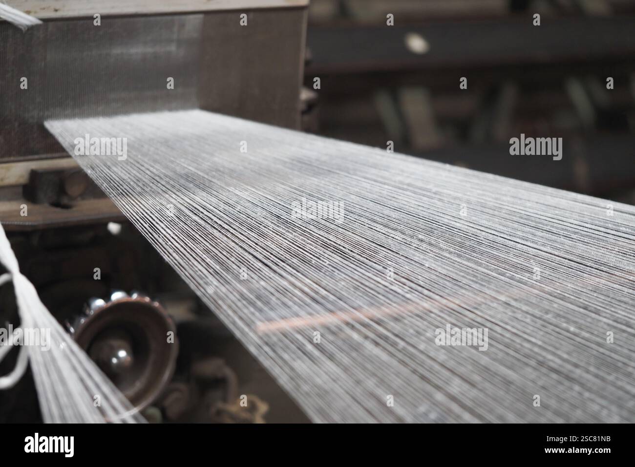 Textile factory machine weaving threads in industrial setting Stock ...