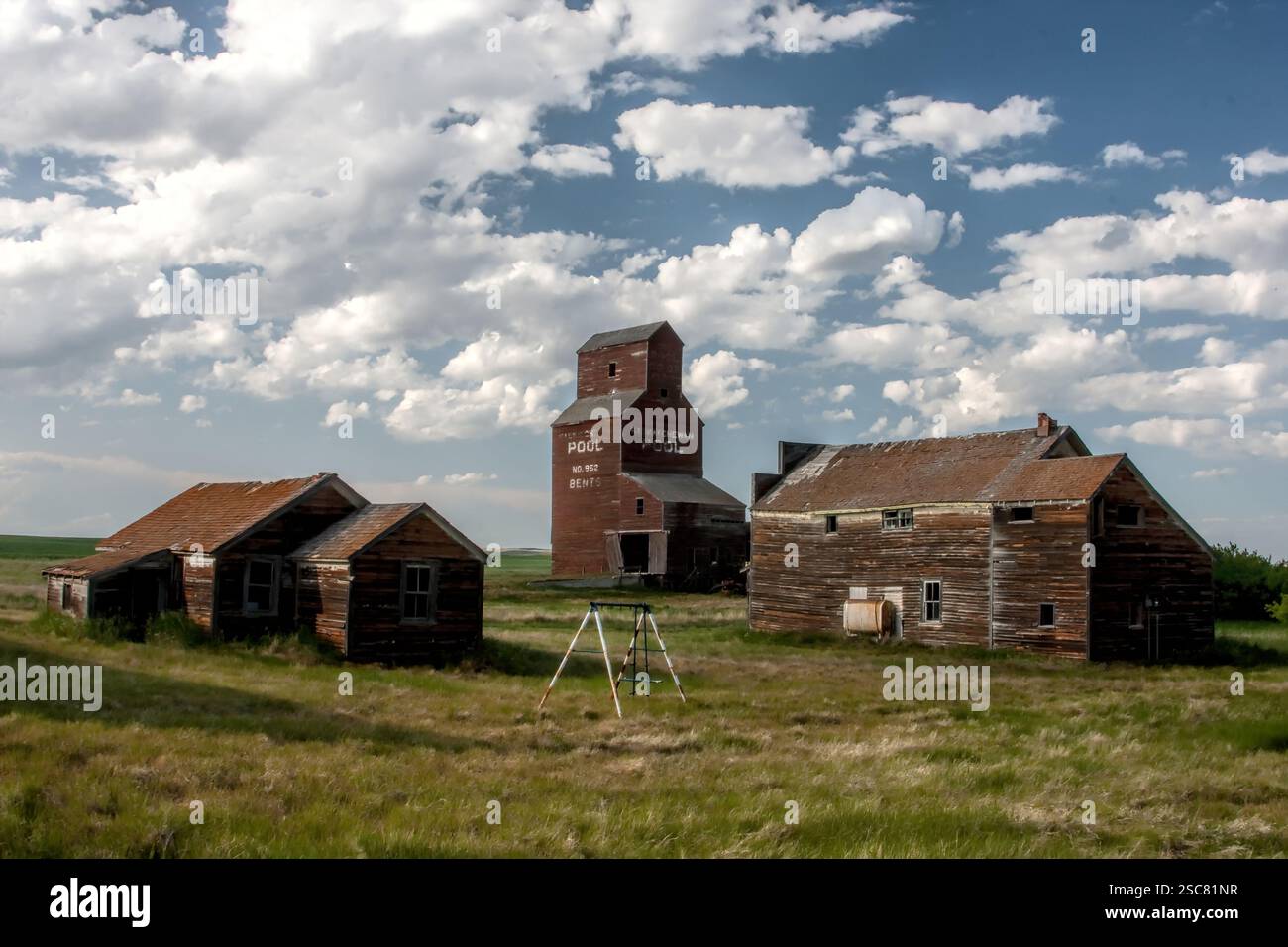A small, rural town with a few old buildings and a tall grain silo. The ...