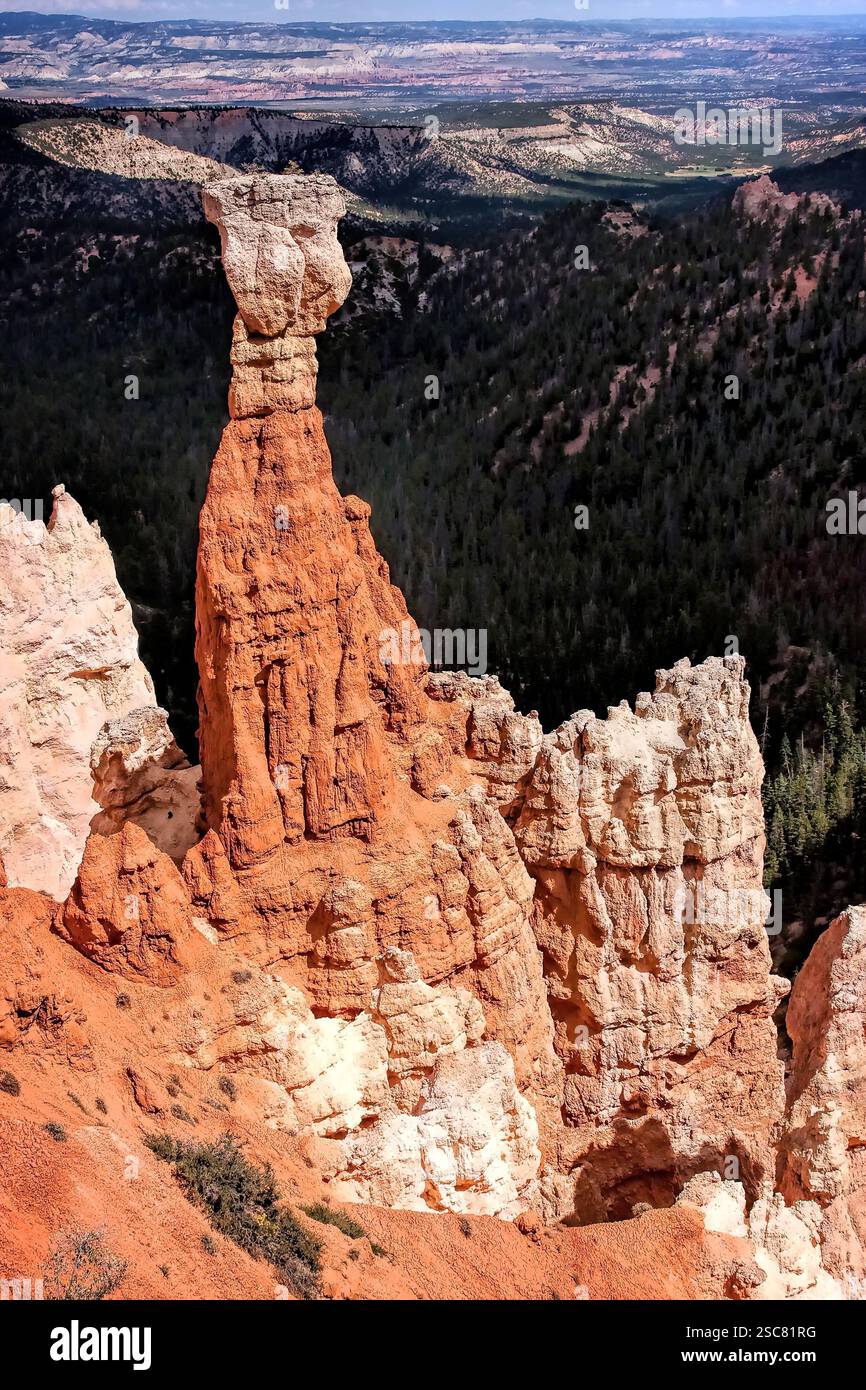 A large rock formation with a pointy top. The rock is brown and white ...