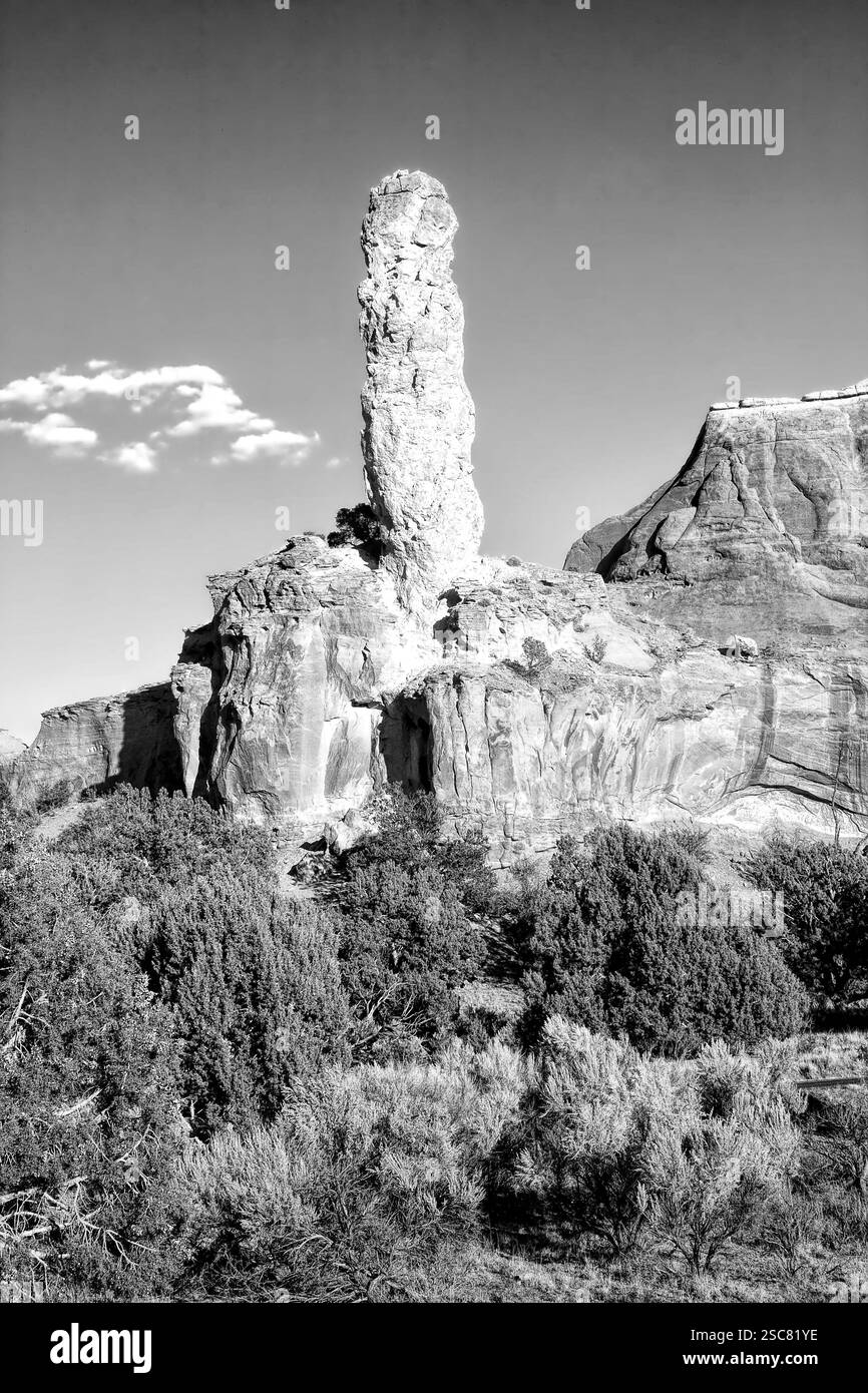 A large rock is on top of a hill. The rock is very tall and has a ...