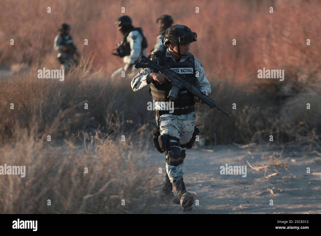 Mexican National Guard members patrol along the Mexico-US border in ...