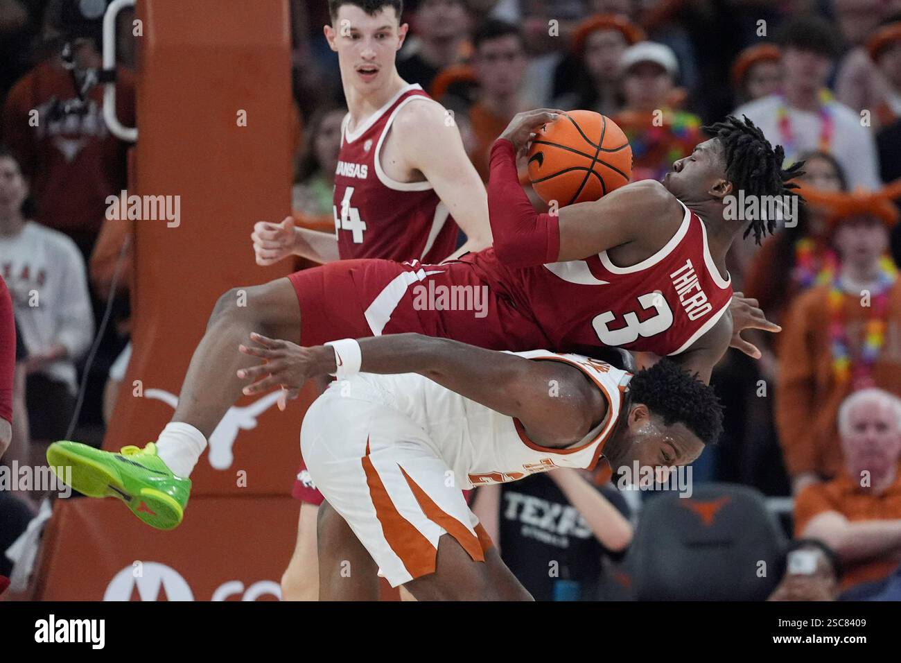 Arkansas forward Adou Thiero (3) lands on Texas forward Ze'Rik Onyema ...