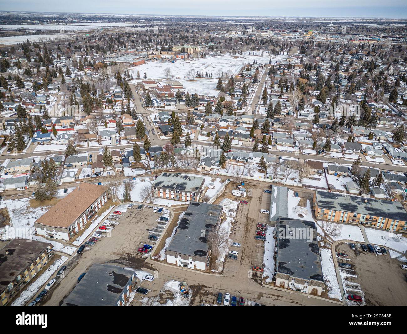 Quiet, snow-covered city with a mix of residential and commercial ...