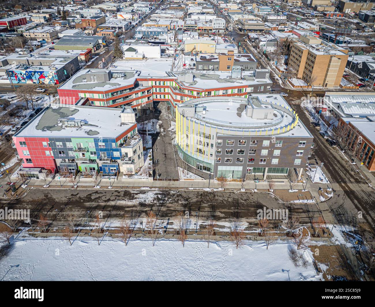 City street with a large building in the middle. The building is multi ...