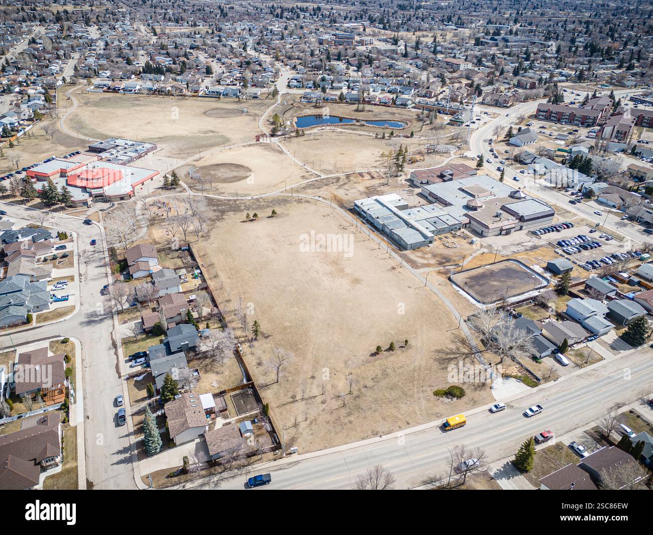 City view of a residential area with a large empty field. The houses ...