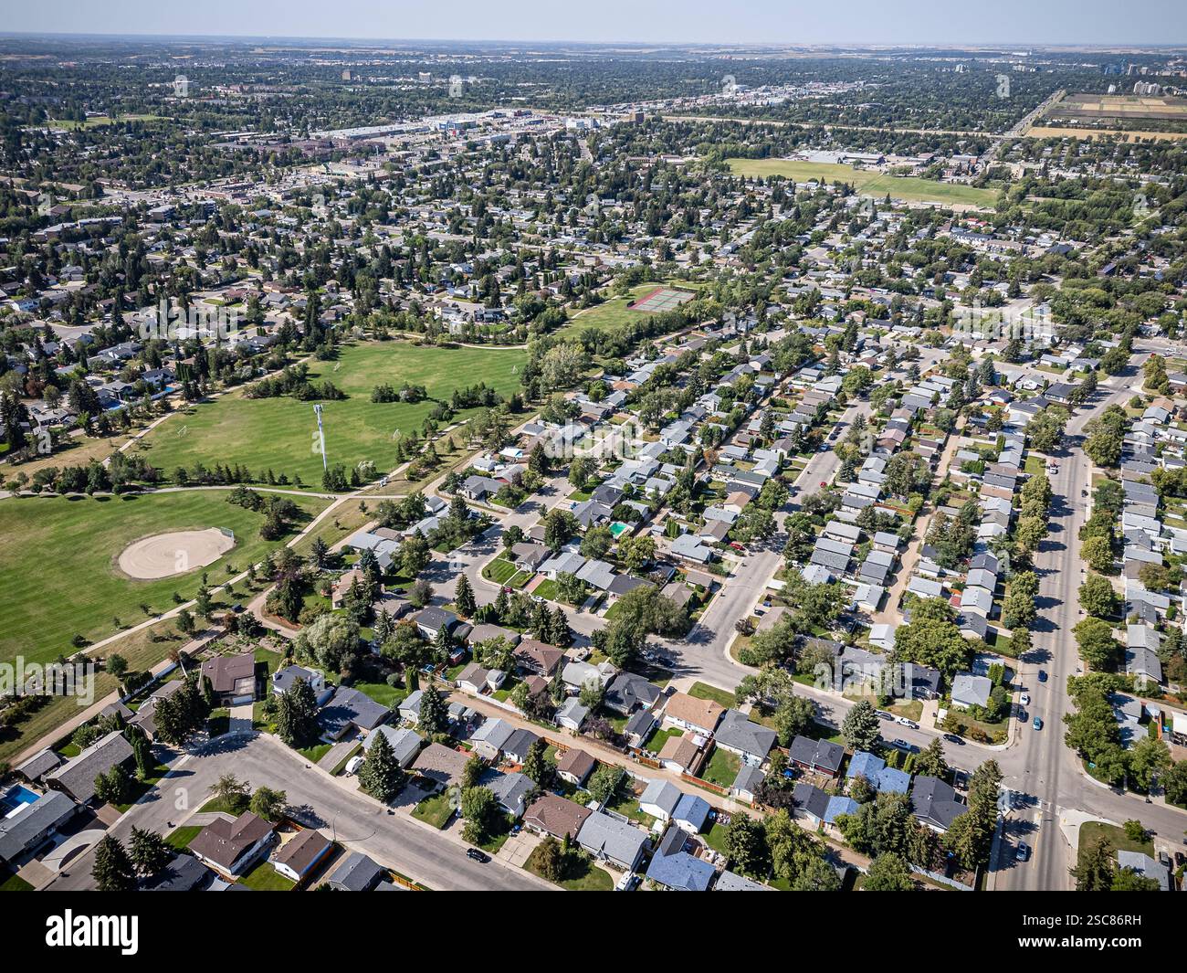 City view of a residential neighborhood with houses and a park. The ...