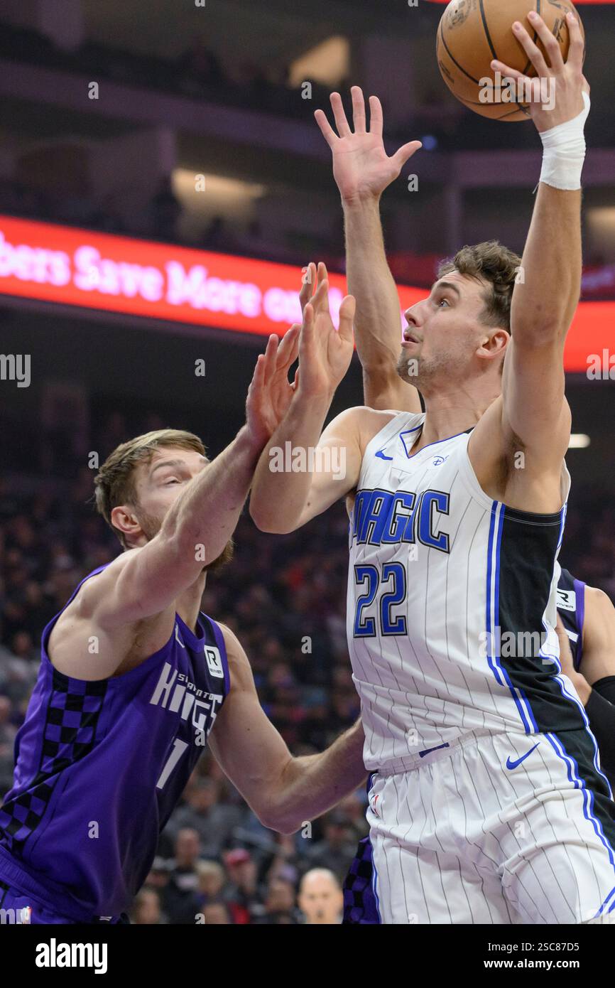 Orlando Magic forward Franz Wagner (22) shoots over Sacramento Kings forward Domantas Sabonis ...