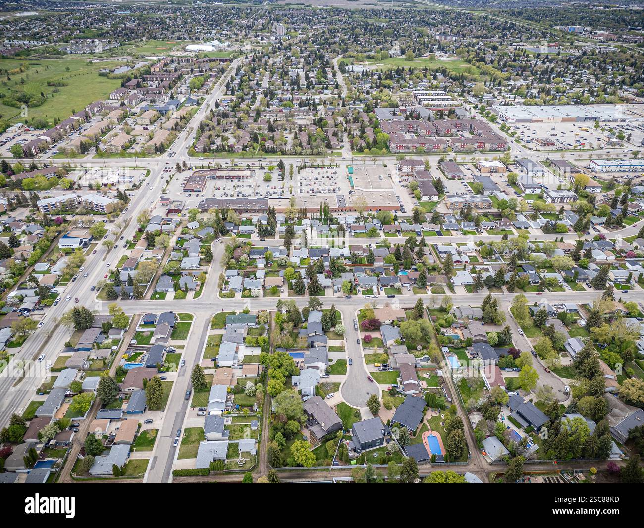 City view from above with houses and a pool. The houses are mostly ...
