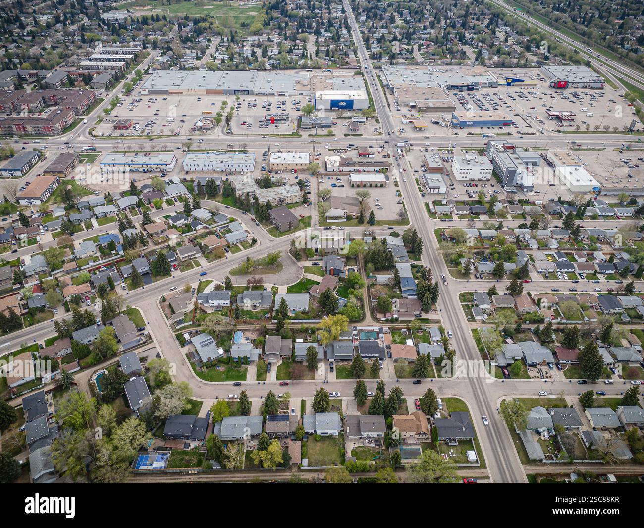 City street view with a large shopping center in the background. The ...