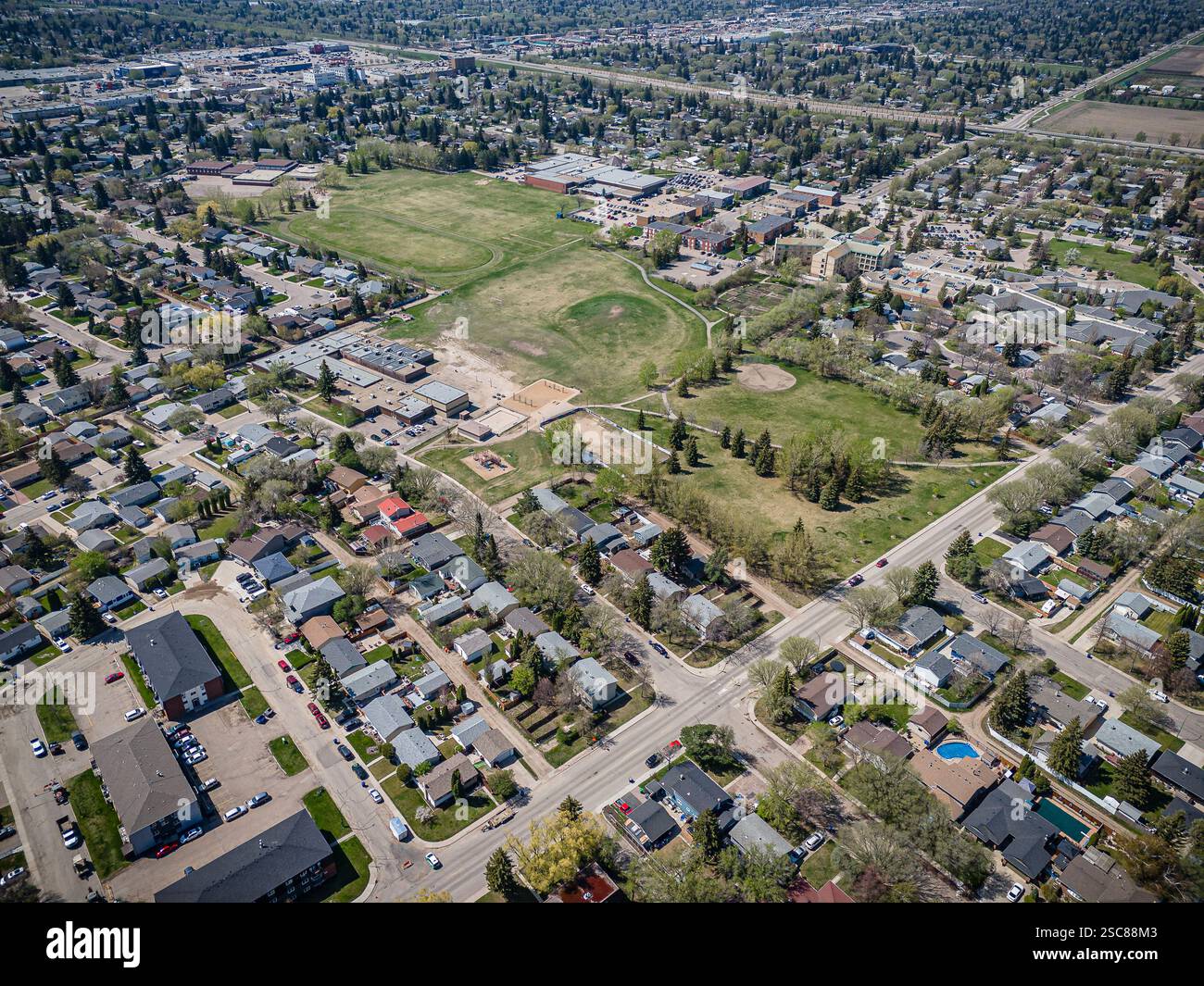 City view with a park in the middle. The park is surrounded by houses ...