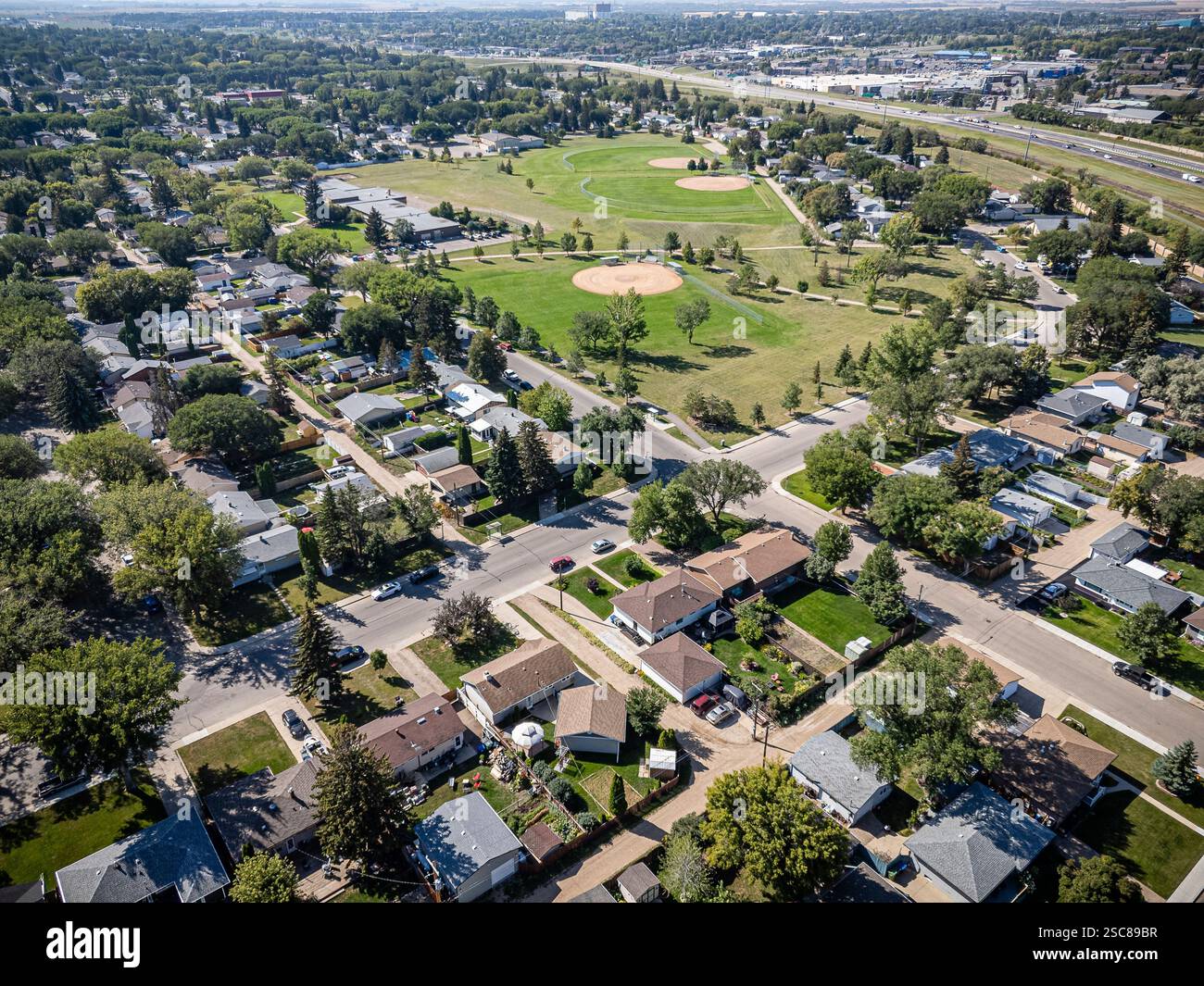 Residential neighborhood with houses and a park. The park is located in ...