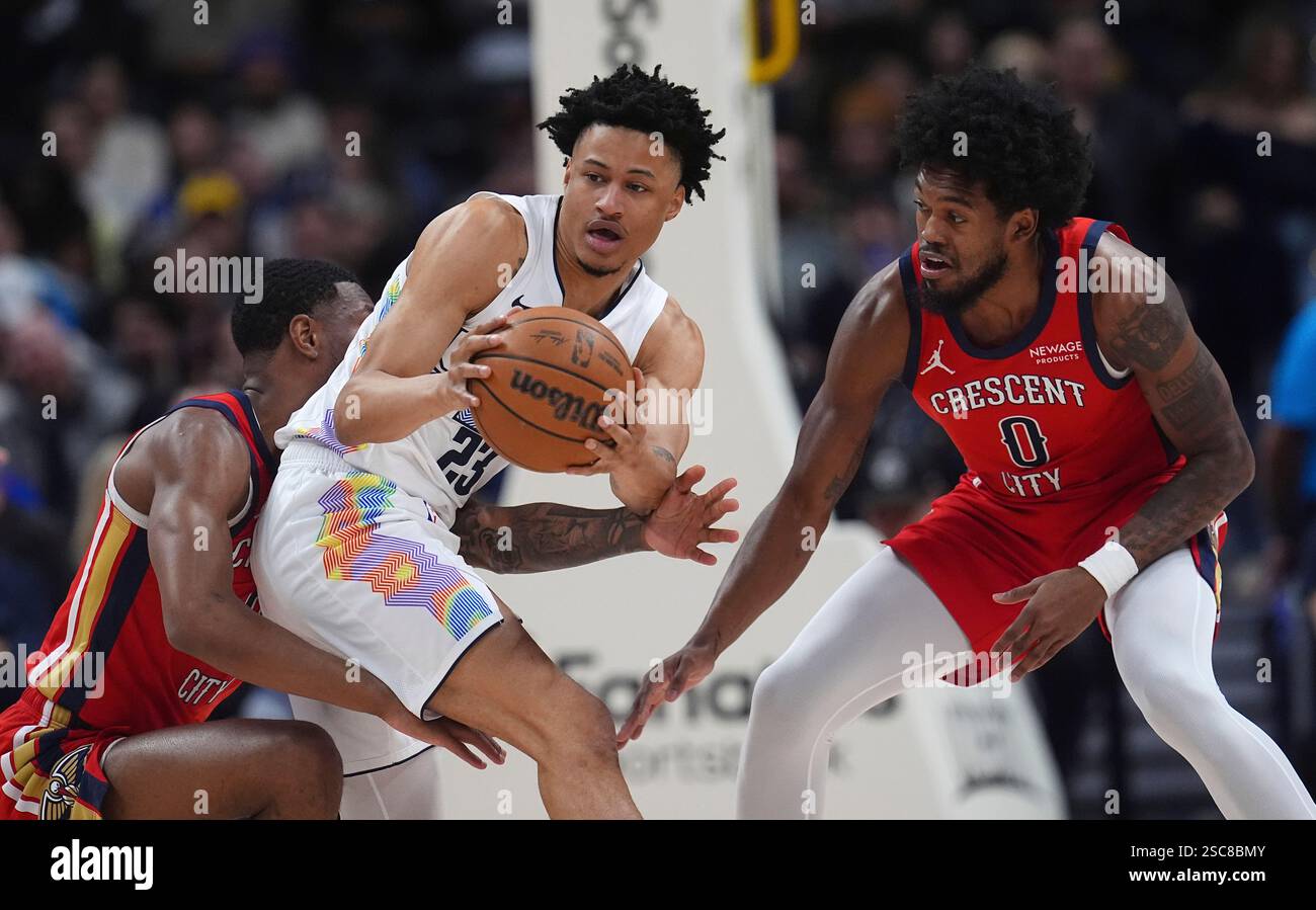 Denver Nuggets guard Trey Alexander, center, recovers a loose ball as ...
