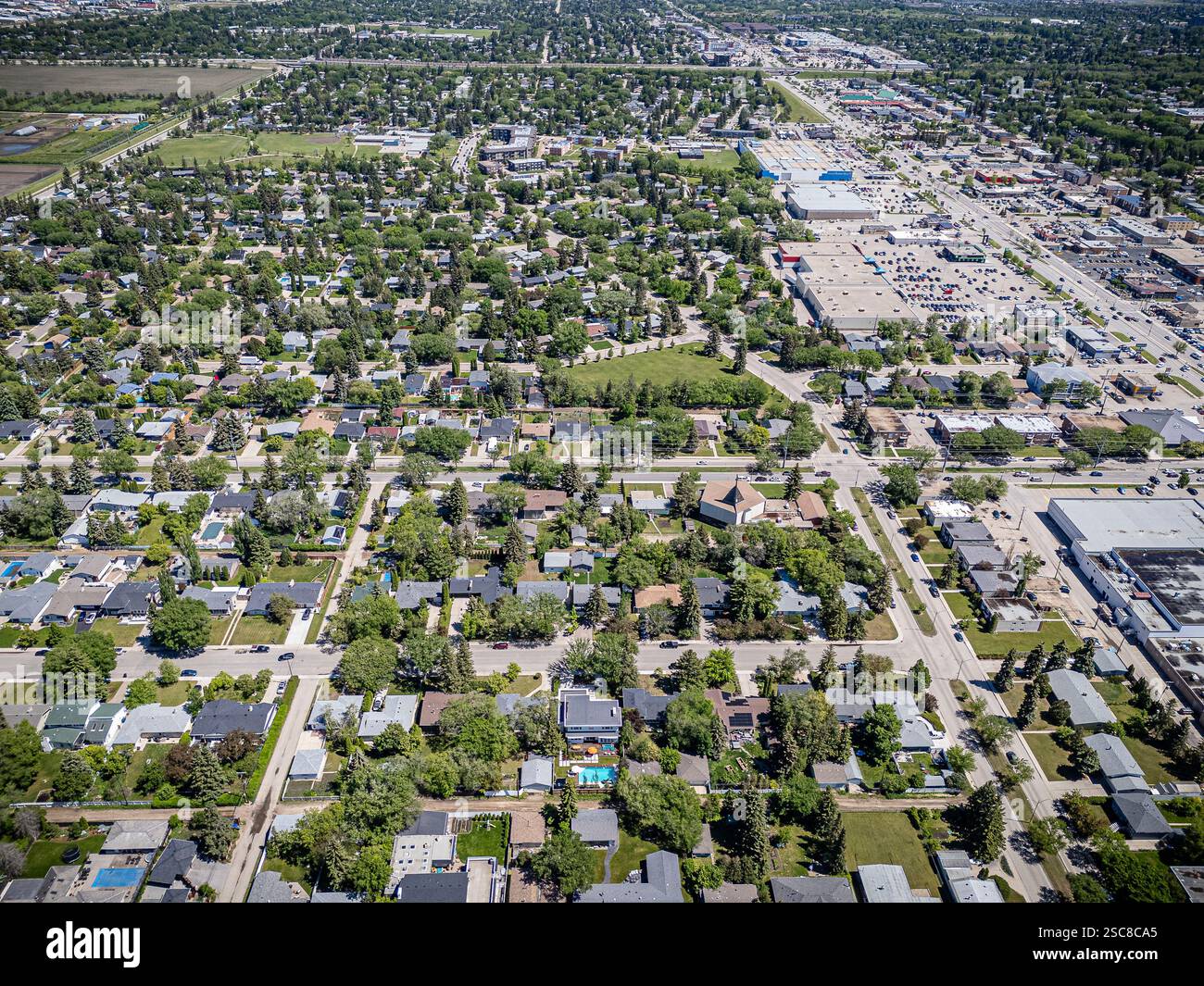 City view from above with many houses and a few cars. The houses are ...