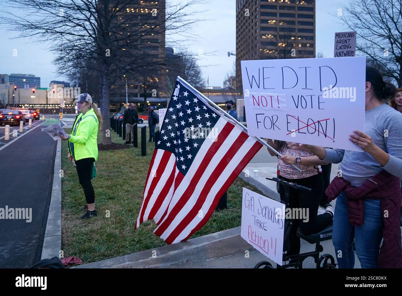Demonstrators hold protest signs outside the Georgia State Capitol as ...
