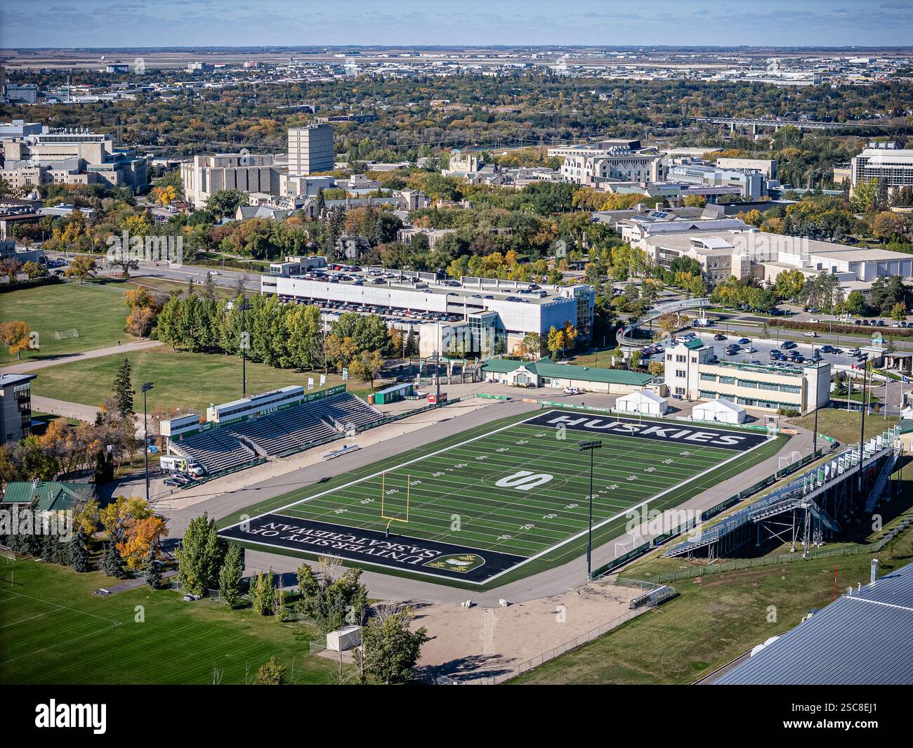 Football field with a large stadium in the background. The stadium is ...