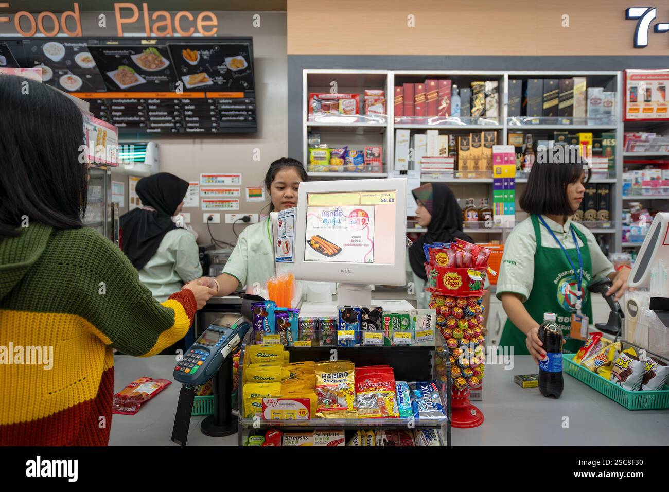Bangkok, Thailand - January 24, 2020: a cashier working behind the cash ...