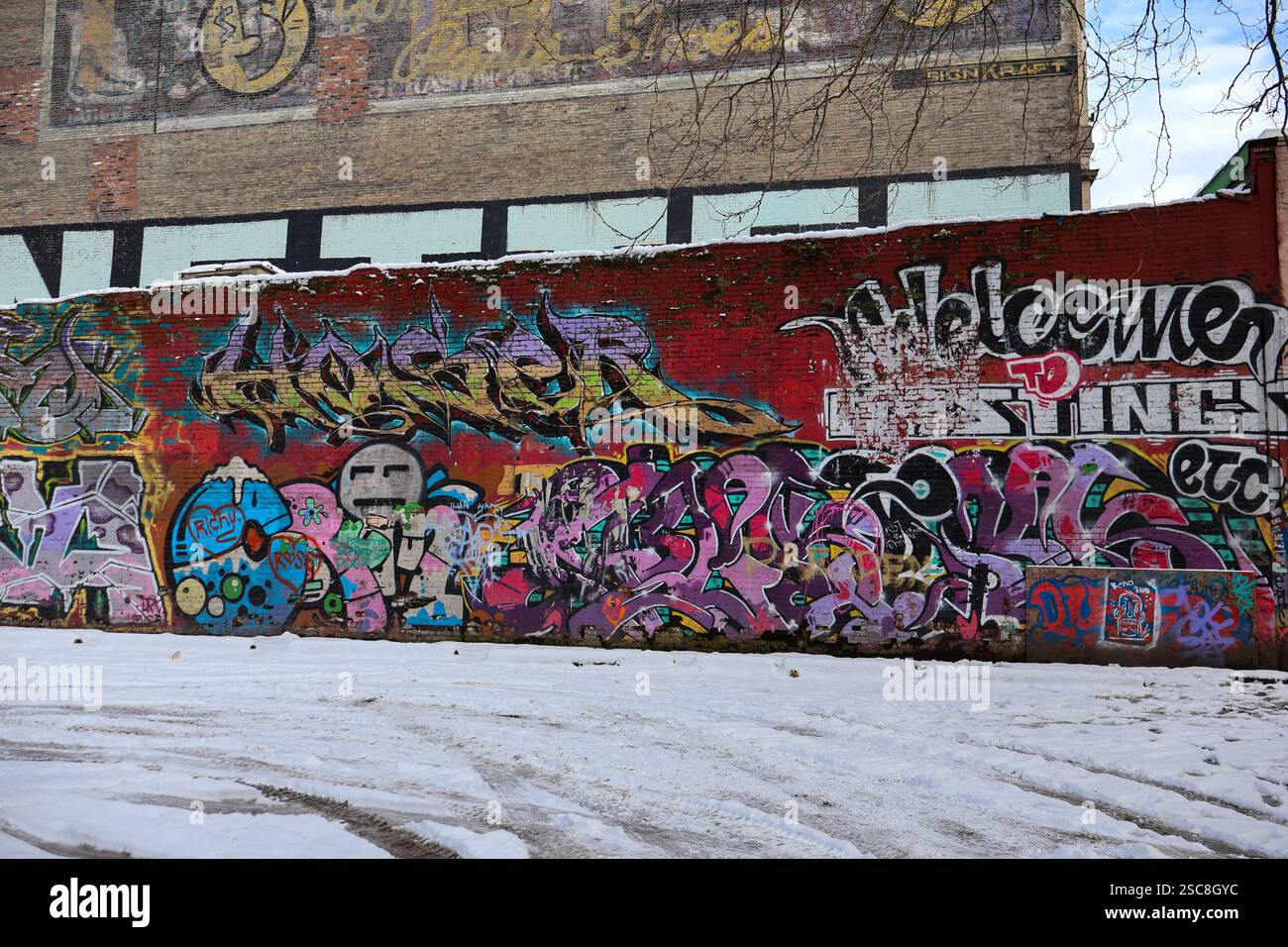 A street art graffiti wall at the back of a parking lot along West ...