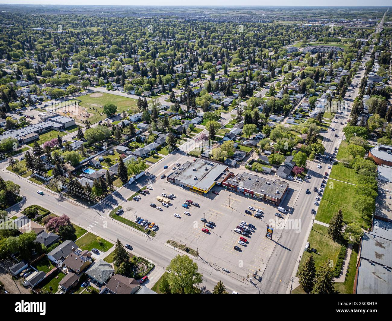 City street with a large shopping center in the middle. The shopping ...