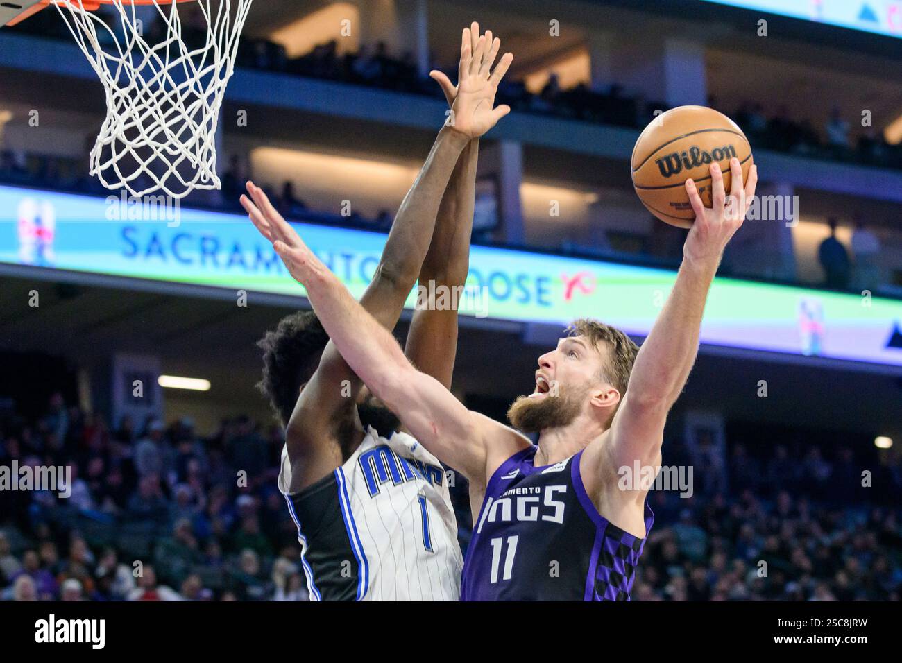 Sacramento Kings forward Domantas Sabonis (11) shoots over Orlando Magic forward Jonathan Isaac ...