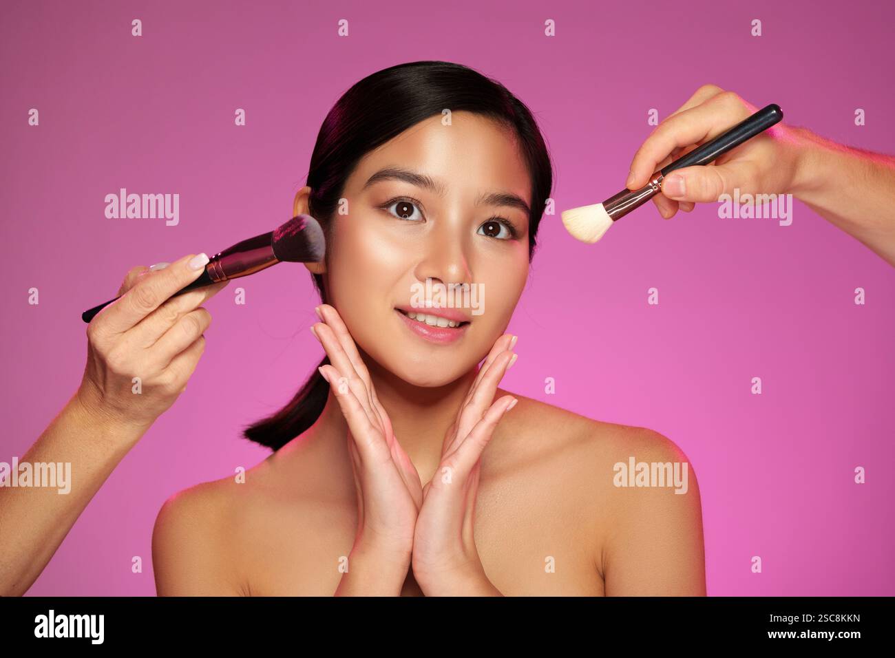 Makeup application on a model with vibrant background during a beauty ...