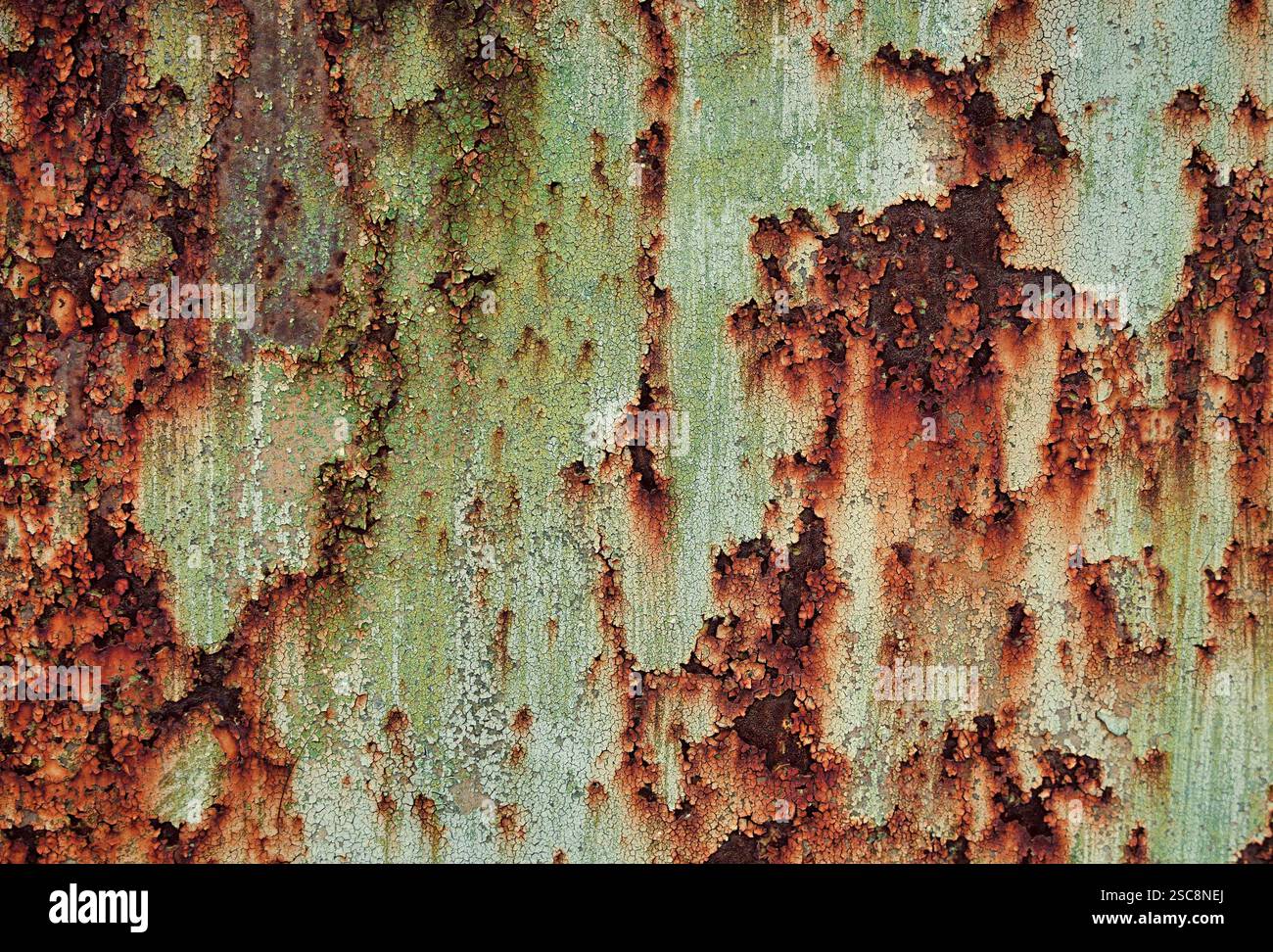 Iron sheet rotting from corrosion with paint residue. Grunge background ...