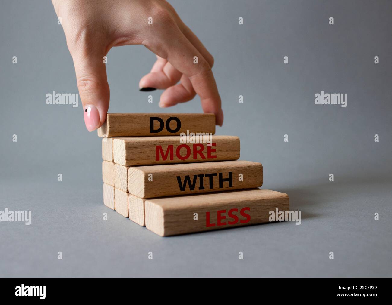 Do more with less symbol. Concept words Do more with less on wooden ...