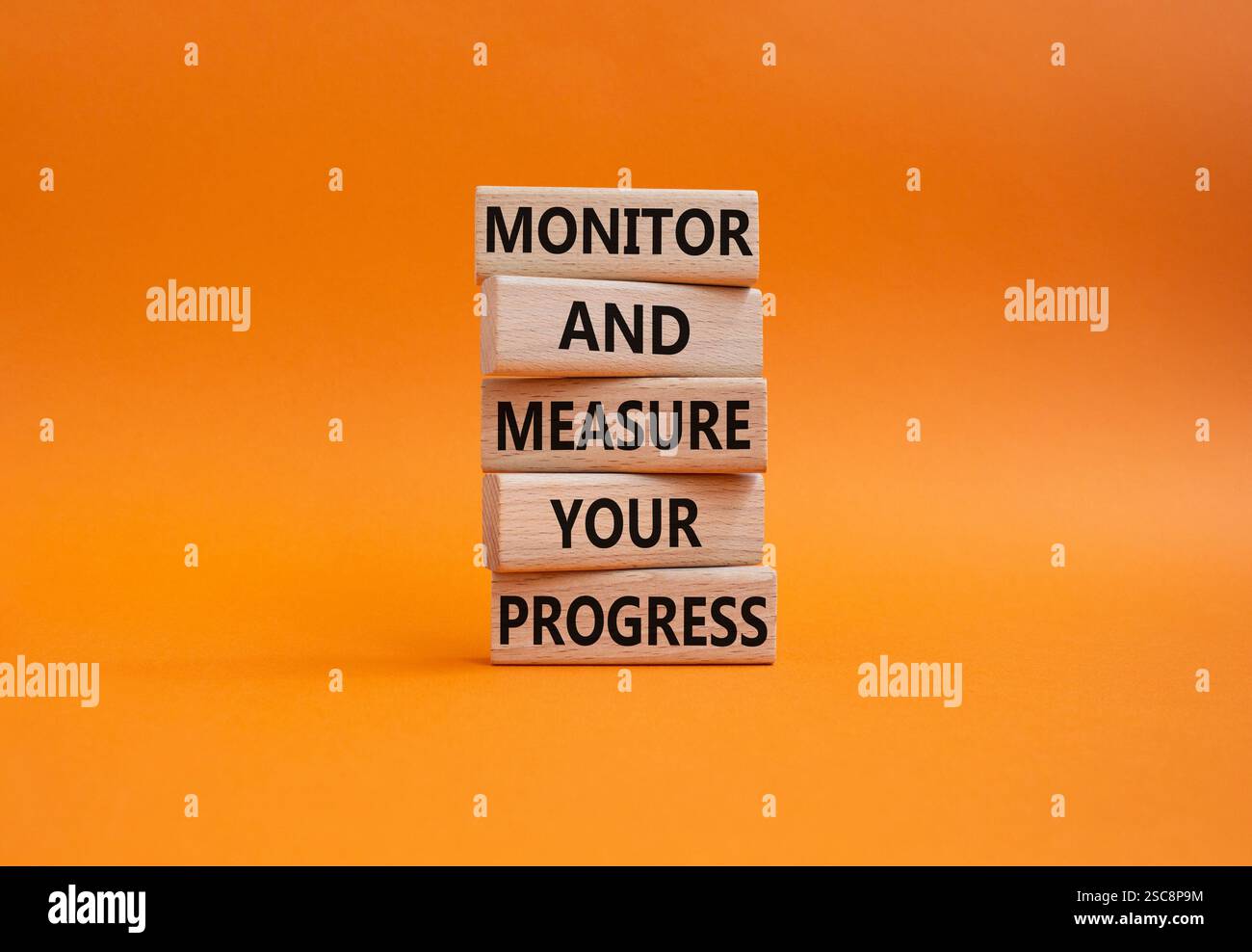 Monitor and Measure your Progress symbol. Wooden blocks with words ...