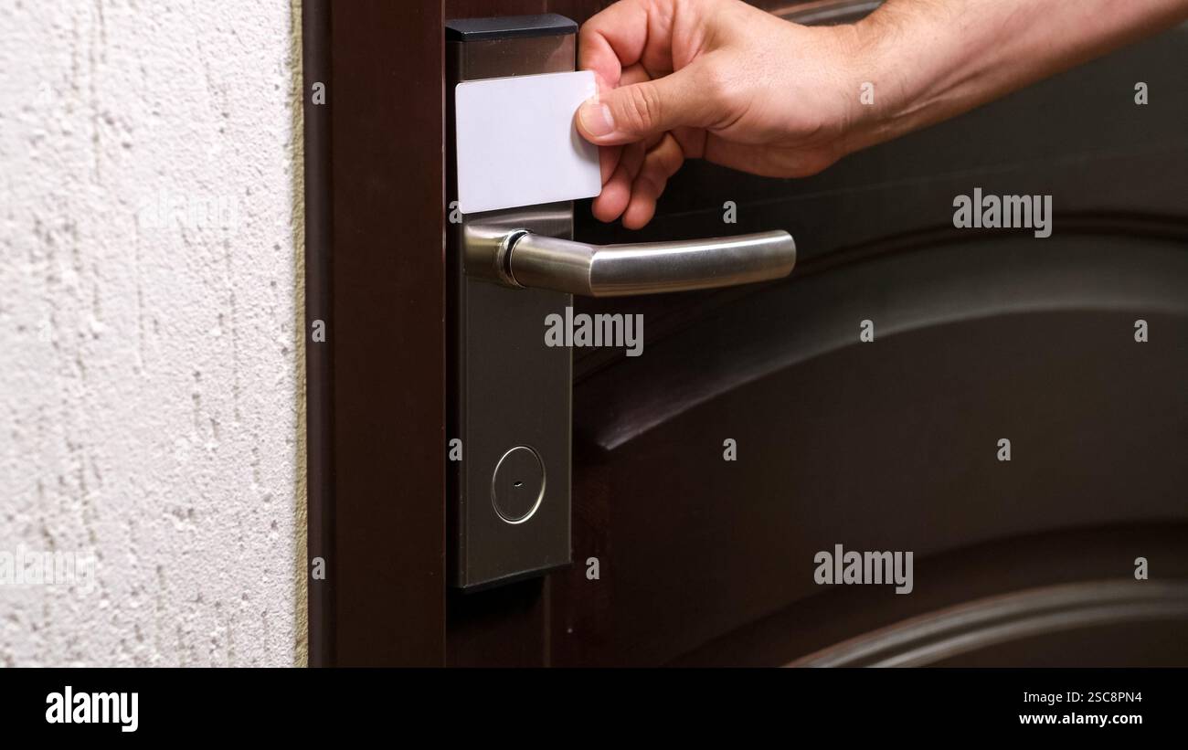 Man hand open hotel room door with electronic magnetic smart card key ...