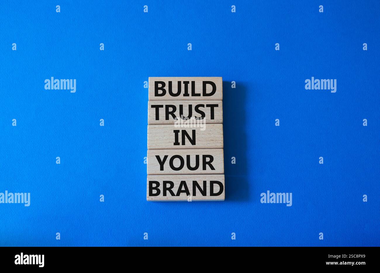 Build trust in your brand symbol. Wooden blocks with words Build trust ...