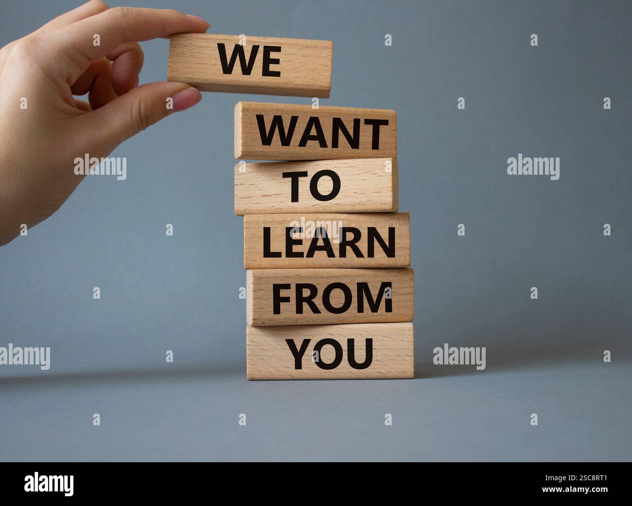 We want to learn from you symbol. Wooden blocks with words We want to ...