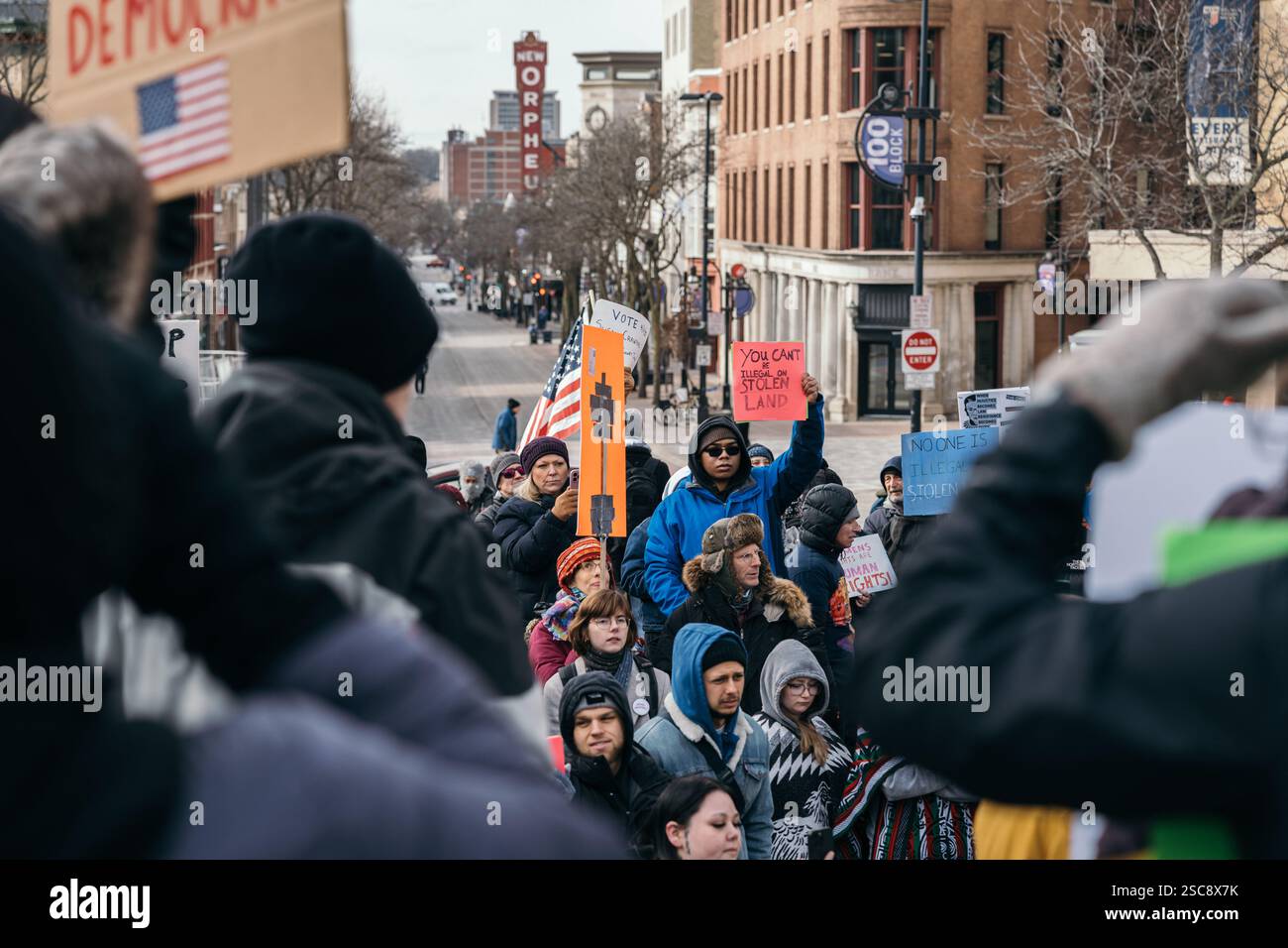 Protestors hold up signs protesting the policys of President Donald ...