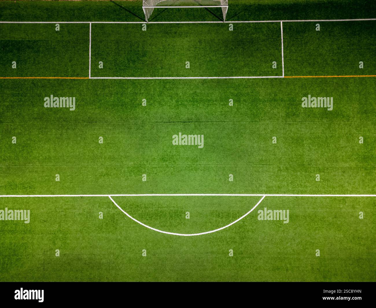 Aerial top-down view of a football field with a green artificial turf ...