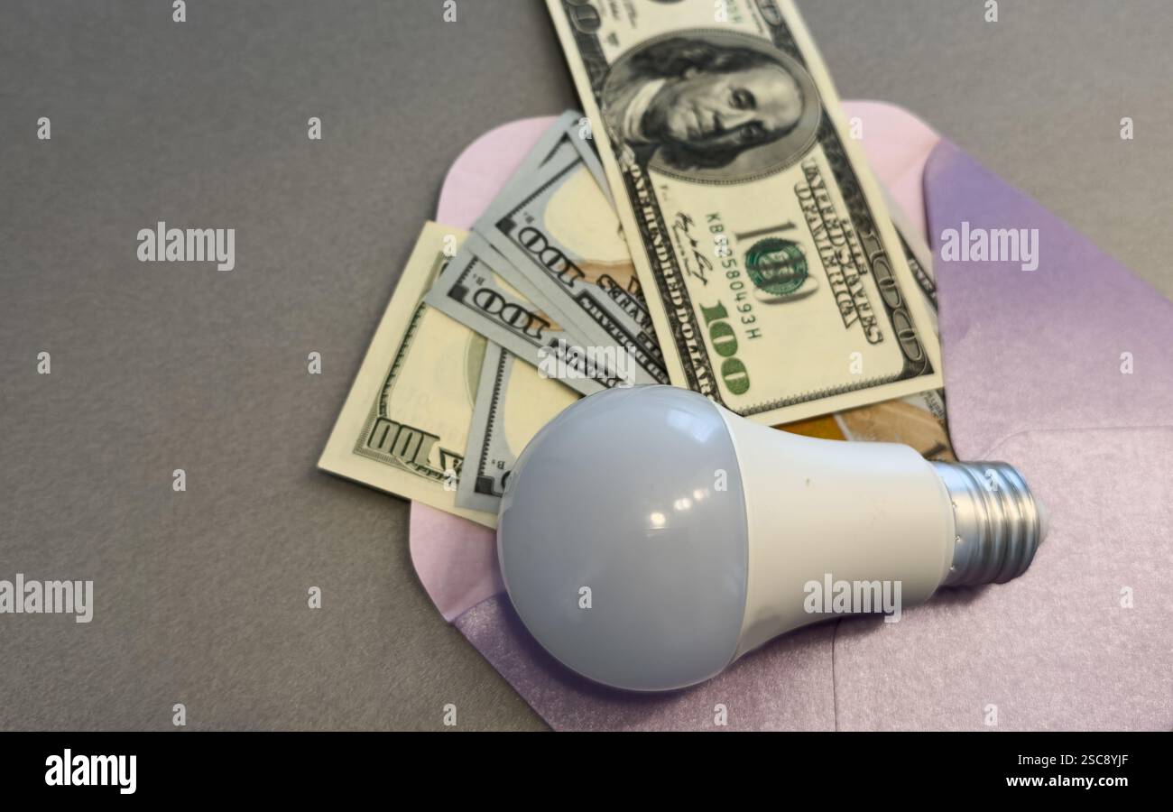 CFL Fluorescent Light Bulb with money dollar cash isolated on white ...