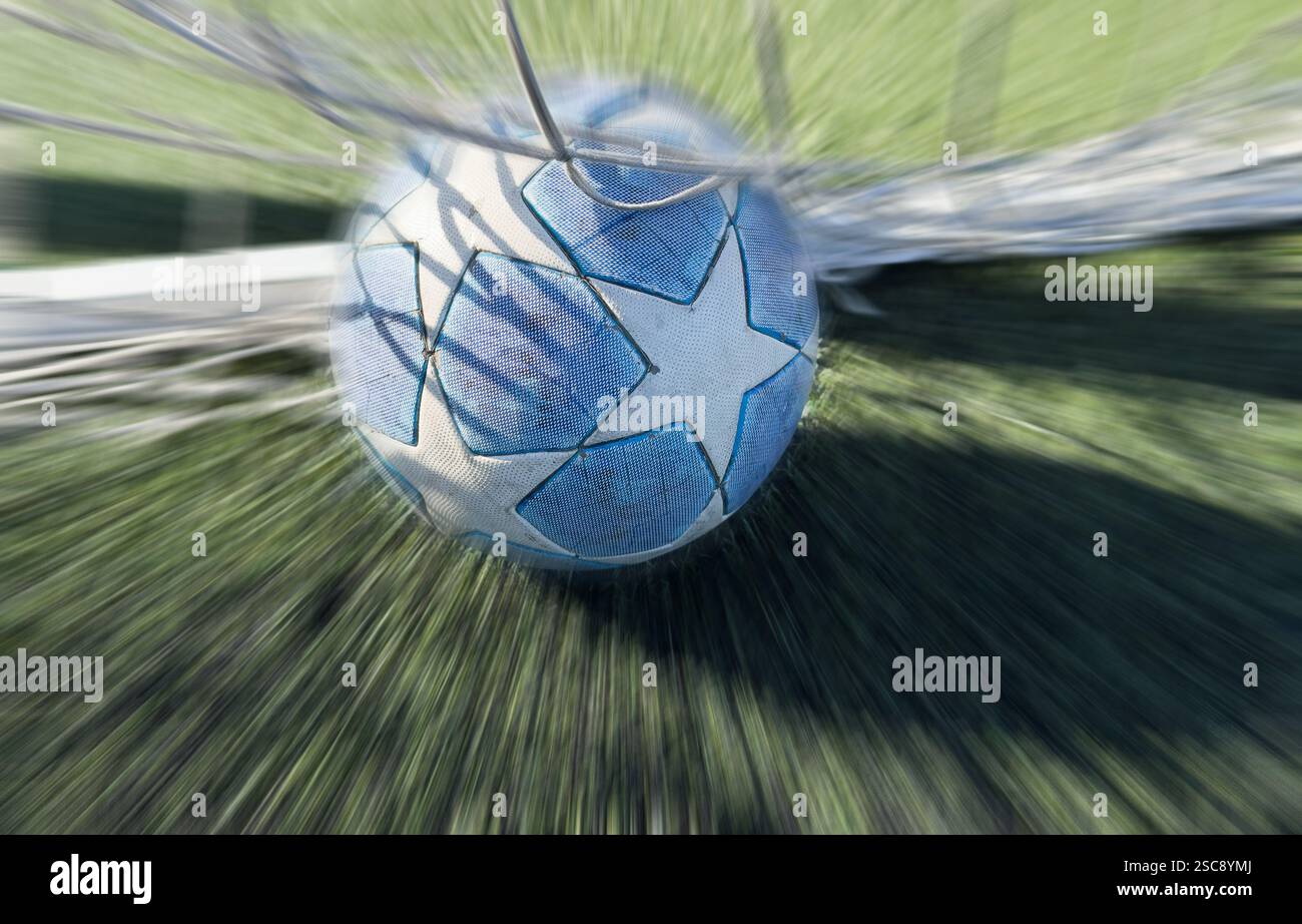 Soccer ball in goal on green background Stock Photo - Alamy