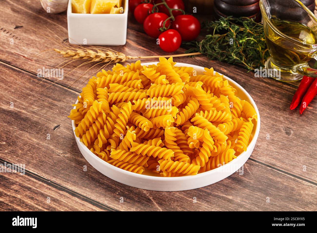 Italian dry raw pasta Fussili for bowl Stock Photo - Alamy