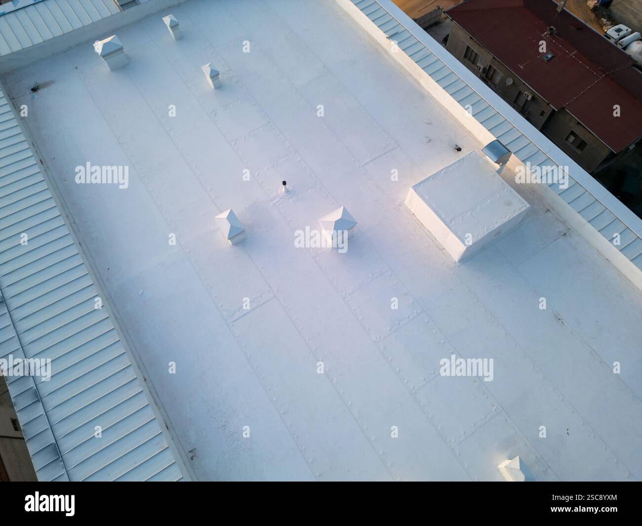 Aerial view of a white industrial rooftop showcasing a clean ...