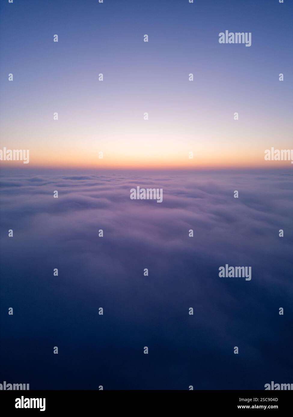 Aerial drone view above clouds at sunrise, high-altitude misty ...