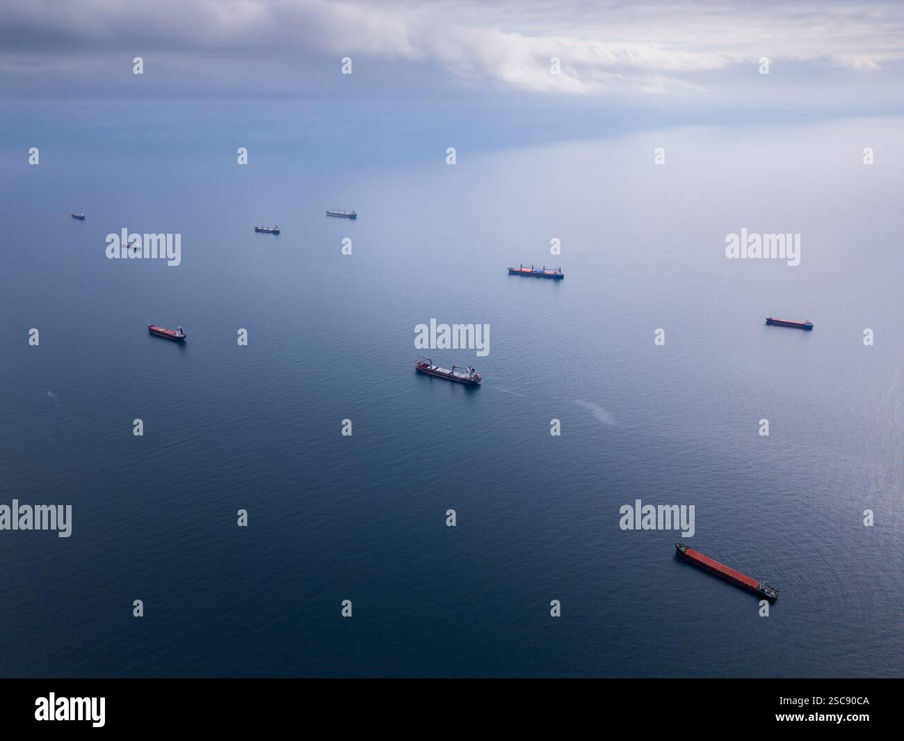An aerial perspective of cargo ships floating on the open sea ...