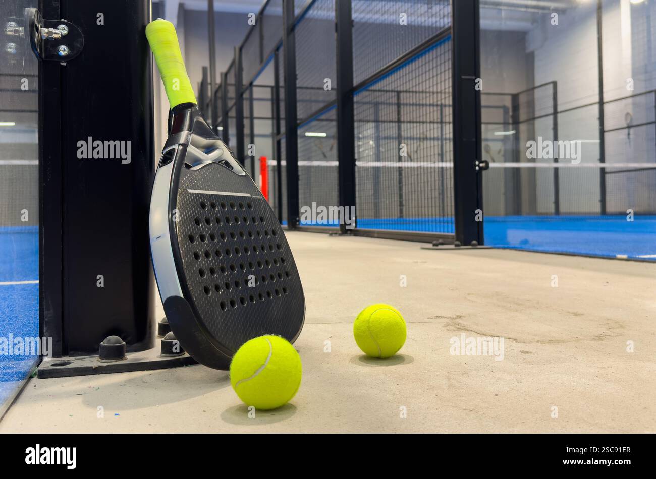 padel racket on a padel blue court with a ball Stock Photo - Alamy