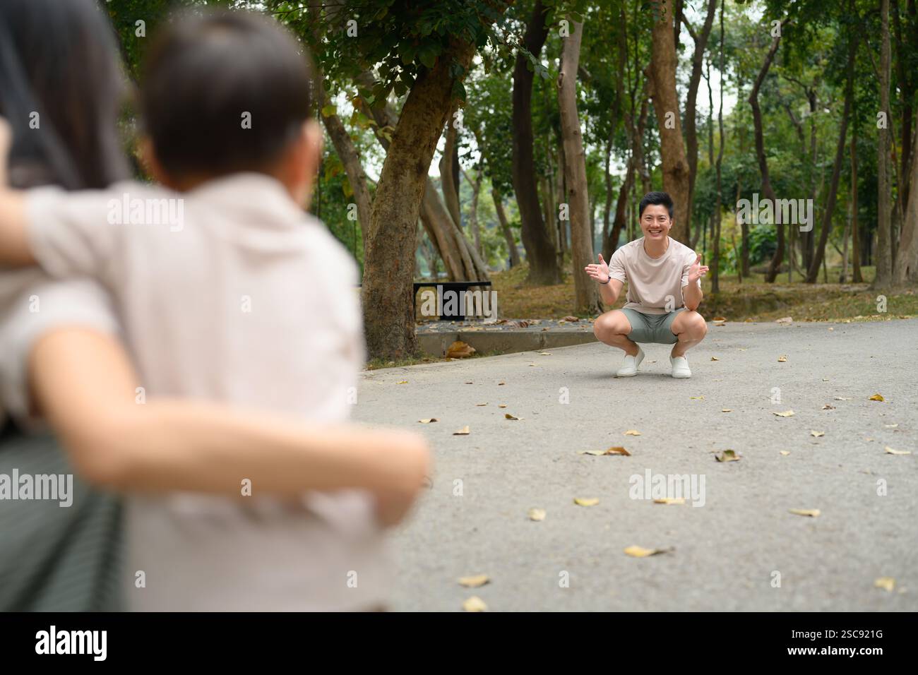 Excited little child running to father with open arms in the park Stock ...