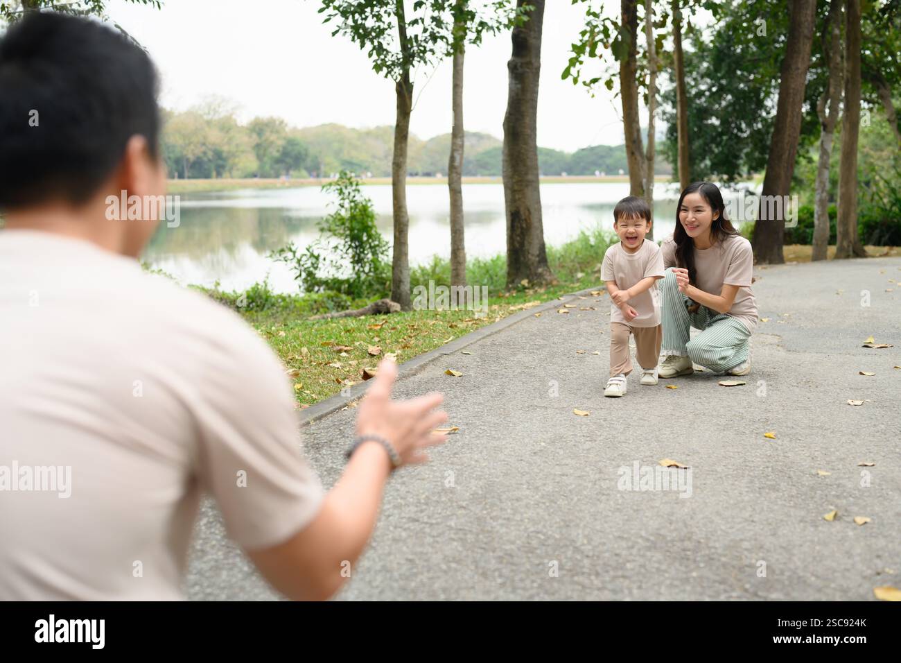 Excited little child running to father with open arms in the park Stock ...